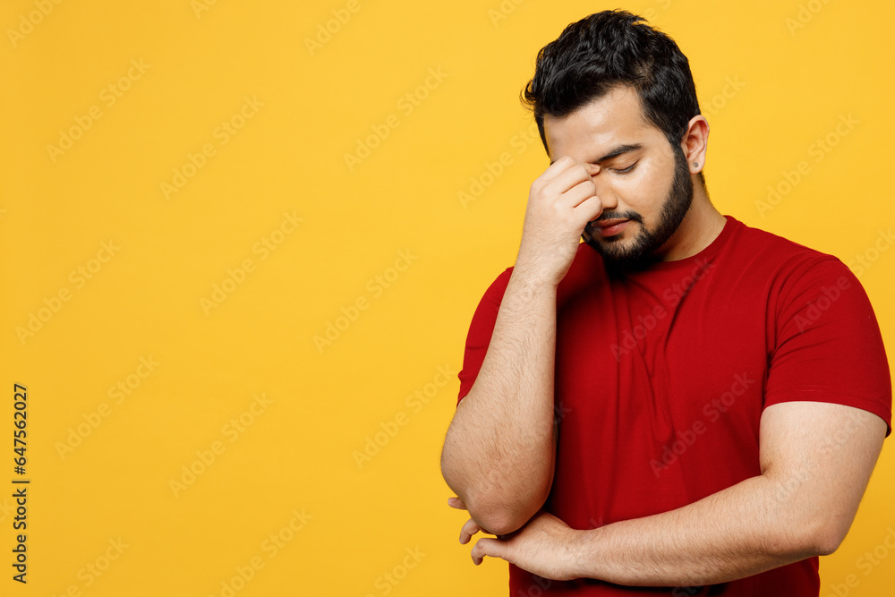 Young sad sick ill tired weary Indian man he wearing red t-shirt casual ...