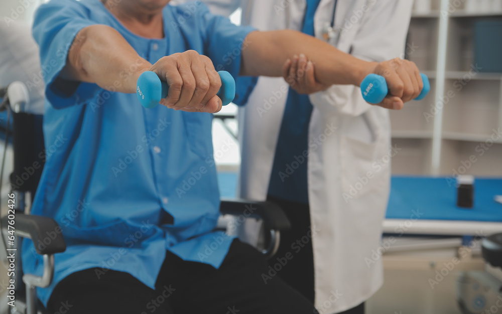 Asian older aged man doing physiotherapist with support from nurse ...