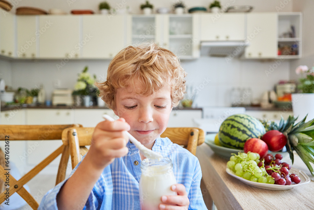 Cute boy eating fresh parfait at home Stock Photo | Adobe Stock