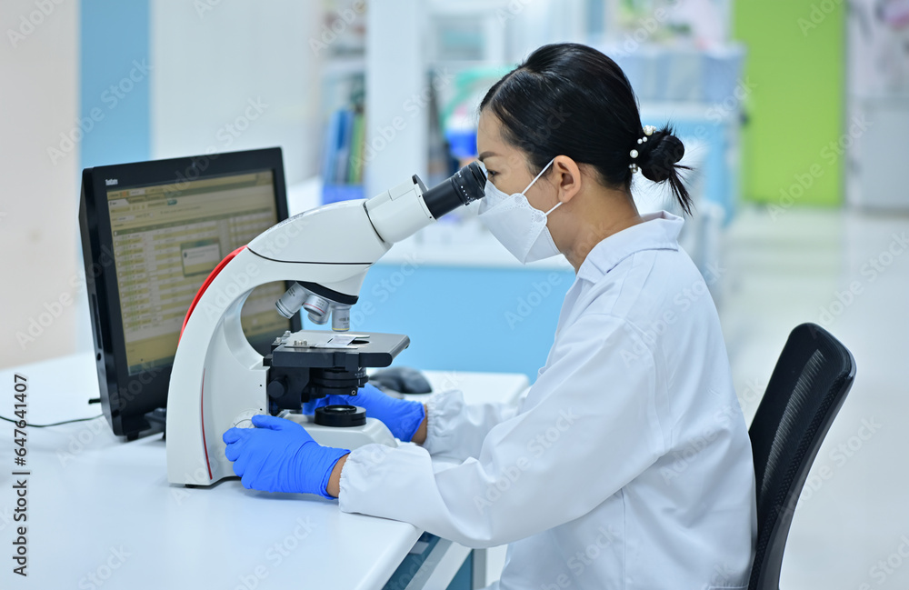 Medical Science Laboratory: Portrait of a scientist looking under a ...