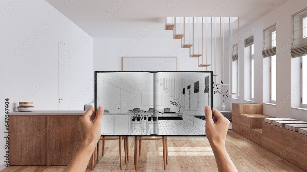 Hands holding notepad with dining and living room design blueprint ...