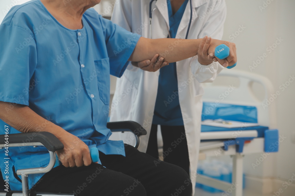 Asian older aged man doing physiotherapist with support from nurse ...