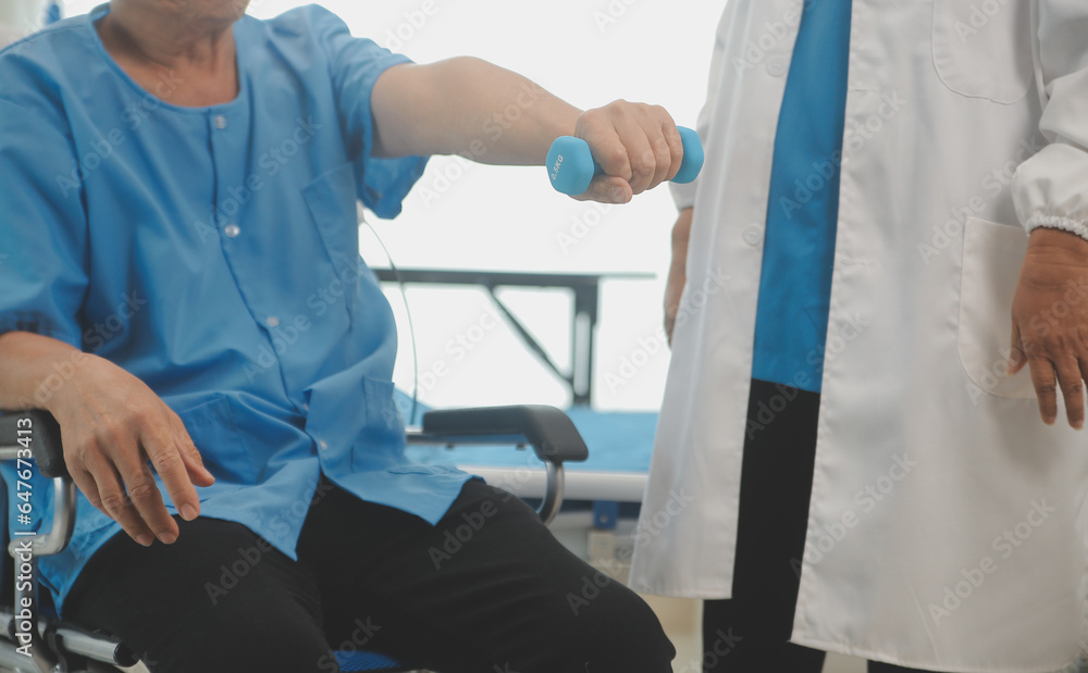 Asian older aged man doing physiotherapist with support from nurse ...