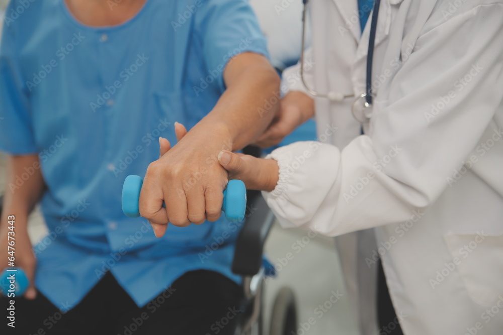 Asian older aged man doing physiotherapist with support from nurse ...