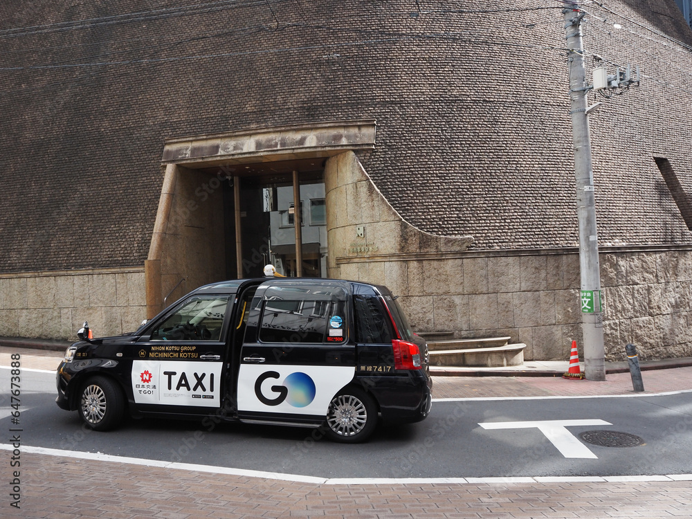 TOKYO, JAPAN - September 14, 2023: A taxi on a street in Tokyo's ...