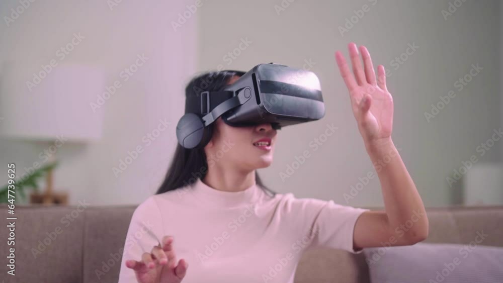 young attractive casual asian female woman relaxing and playing VR ...