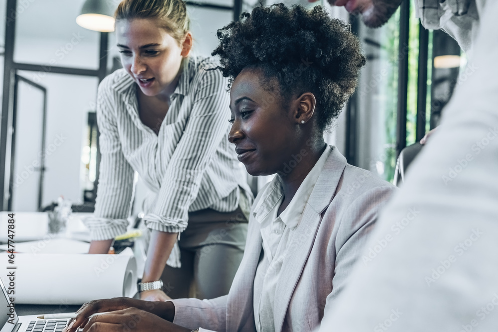 Pretty black female manager discussing ideas at the office of a new ...