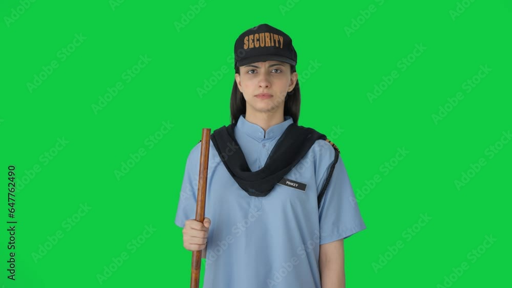Angry Indian female security guard staring at someone Green screen ...
