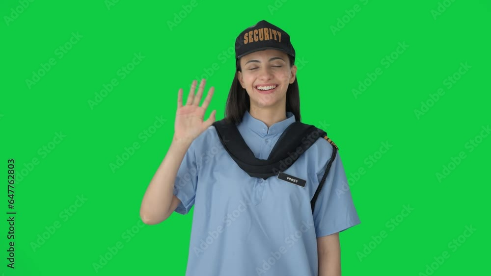 Happy Indian female security guard waving hello Green screen Stock ...