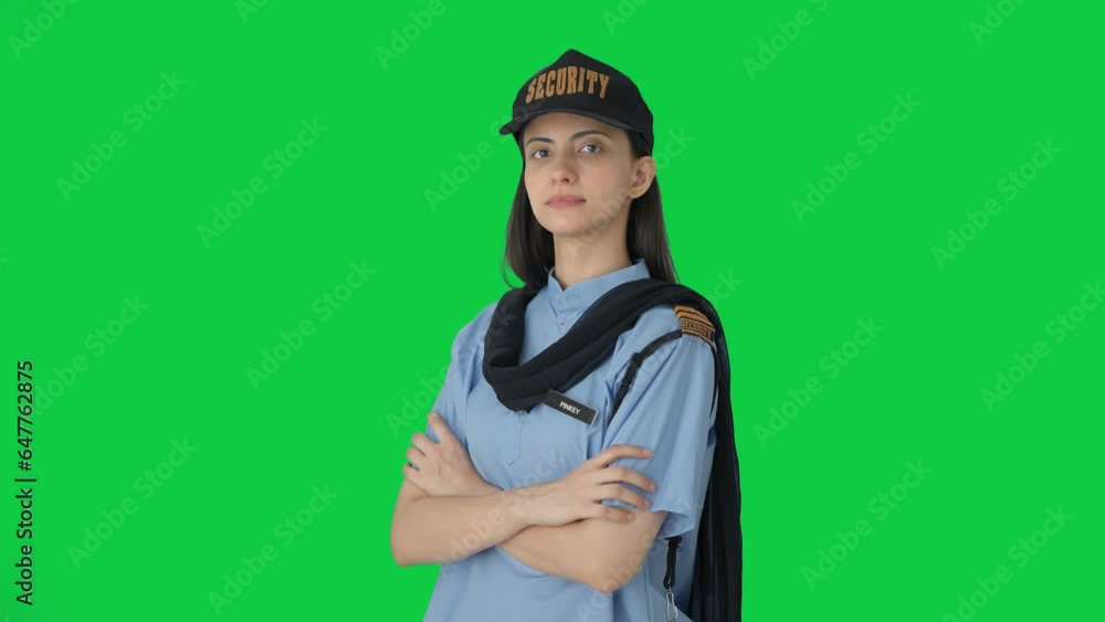 Portrait of Indian female security guard standing crossed hands Green ...