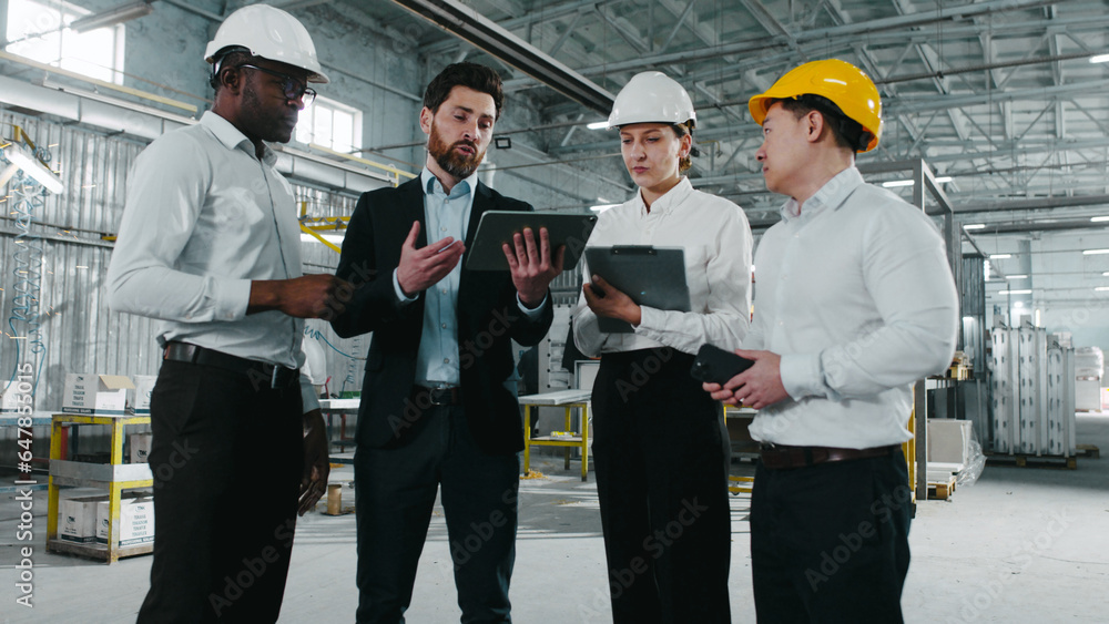 Teamwork at background of working process where welding sparks flying ...