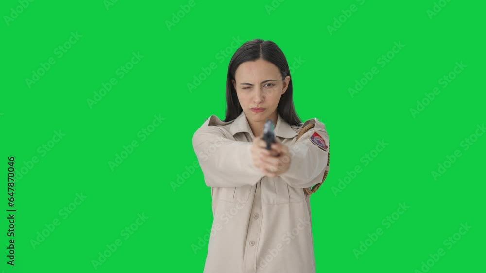 Angry Indian female police officer aiming handgun on someone Green ...