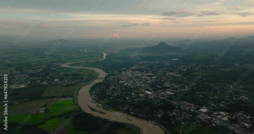 Valencia City with winding river, farmland, and houses. Mt. Kalayo in ...