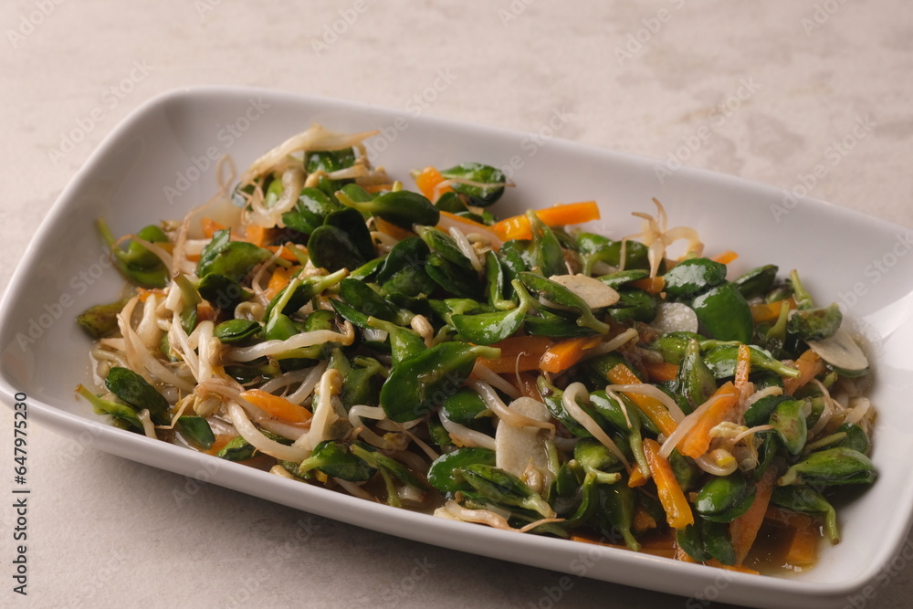 stir-fry bean sprouts, carrots, and katel (soybean shoots). Indonesian ...
