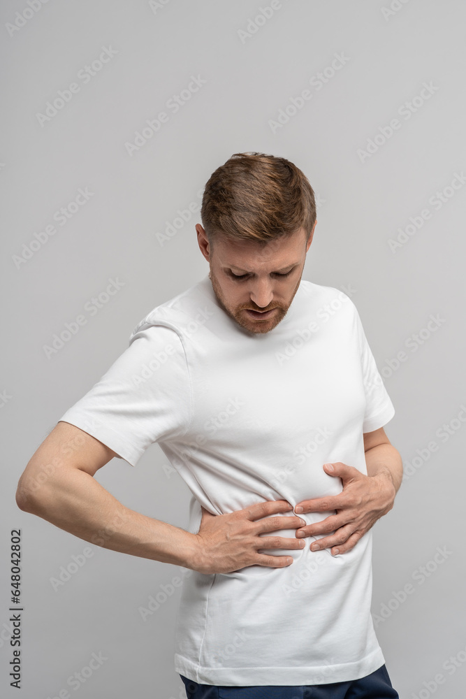 Man having health problems feeling pain spasms in right part of body on ...