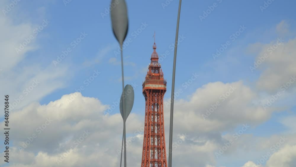 Blackpool Tower with tall seed sculptures swaying in wind and clouds ...
