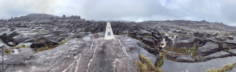 White tripoint marker located on flat topped mount Roraima at the ...