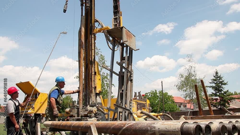 Drilling Rig Workers Drilling Geothermal Well for a Residential ...