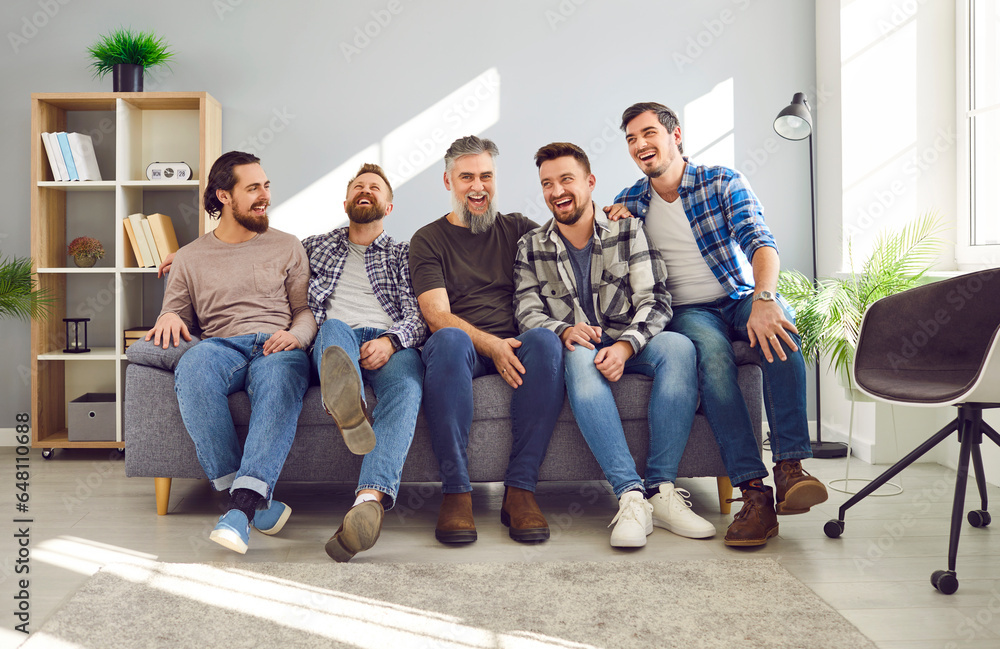 Happy five men sitting on the sofa. Group portrait of cheerful, smiling ...