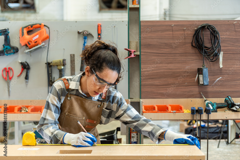 One Strong confident young aged women carpenter standing aim at wood ...