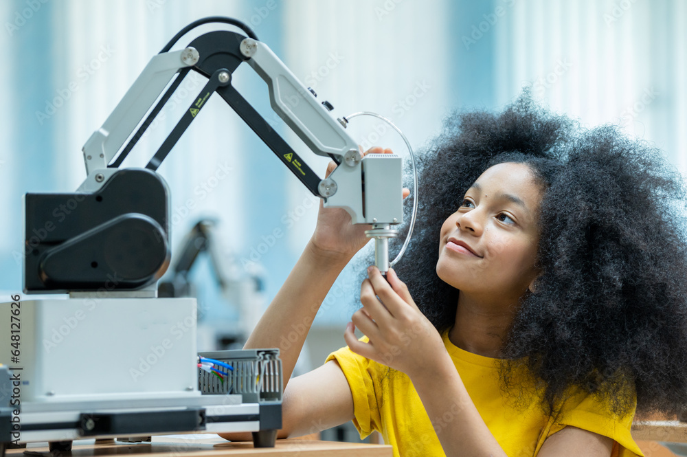 Kid female teen child enjoy Machine Learning Robot arm is Moving Under ...