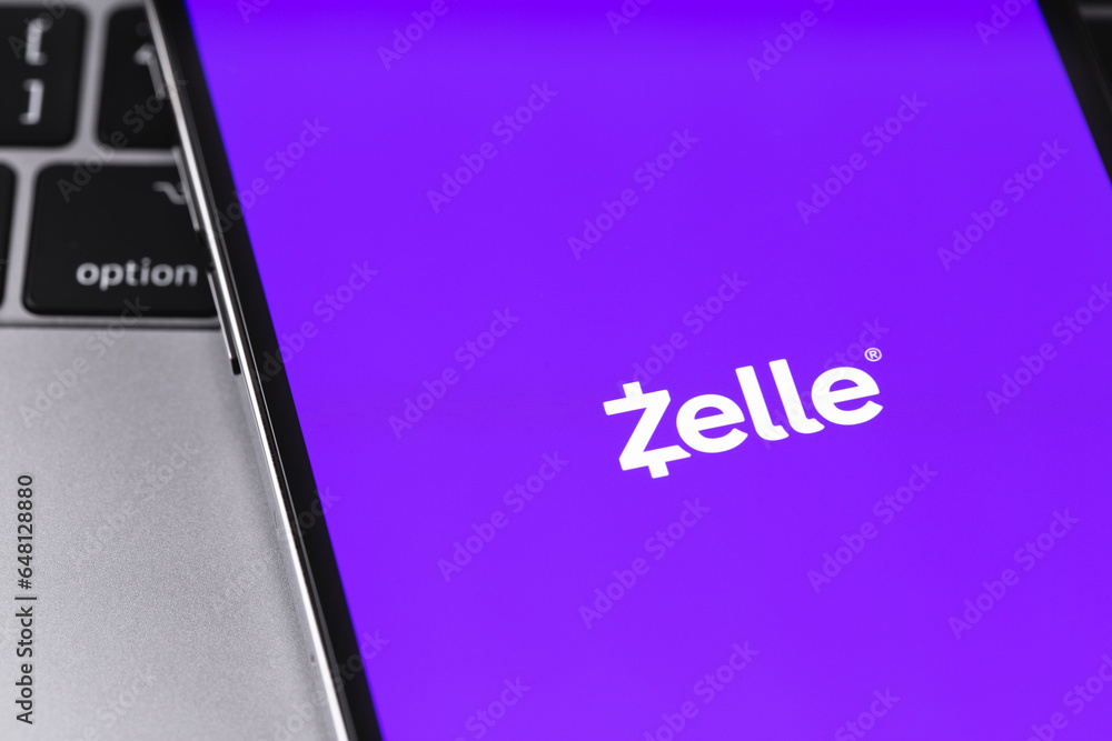 Zelle logo mobile app on a screen smartphone iPhone closeup. Zelle is a ...