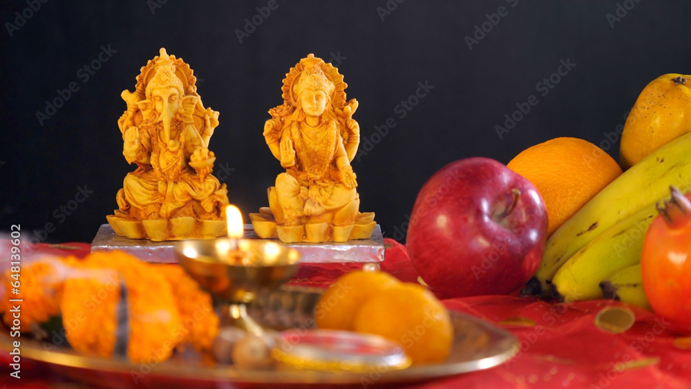 Pooja Thali with a Diya marigold flowers and sweets - Worshipping ...