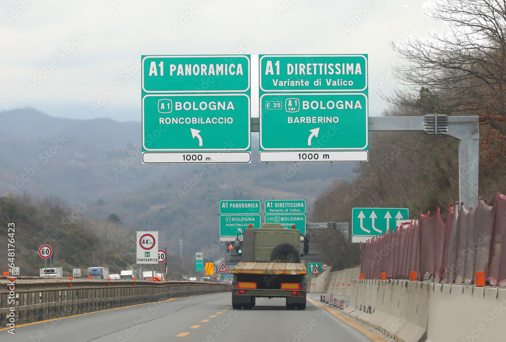 wide road sign in the italian motorway with place of city and two way ...