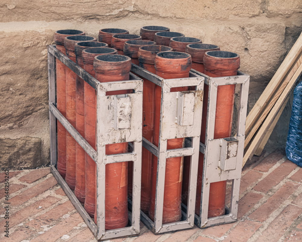 Containers with tubes and pipes laid on ground to light firework show ...