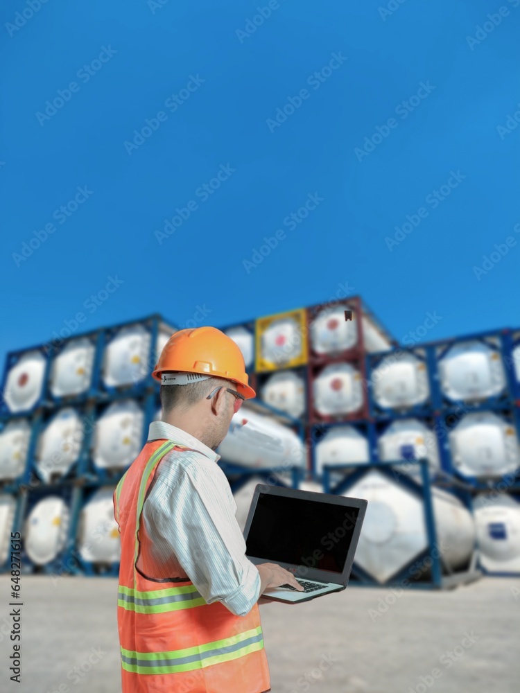 ISO tank : a male officer wearing a safety uniform carrying a laptop ...