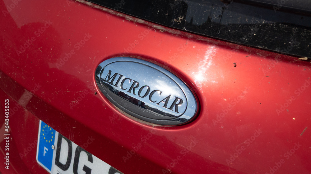microcar brand text on rear car logo sign automobiles mini vehicle ...