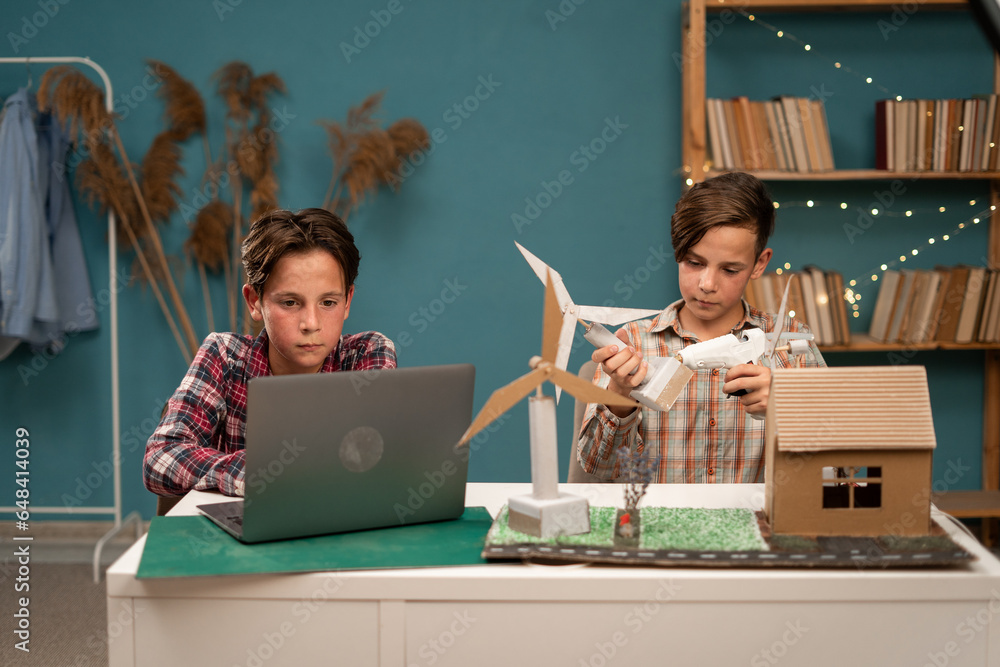 Group of school student learning and discussing about renewable energy ...