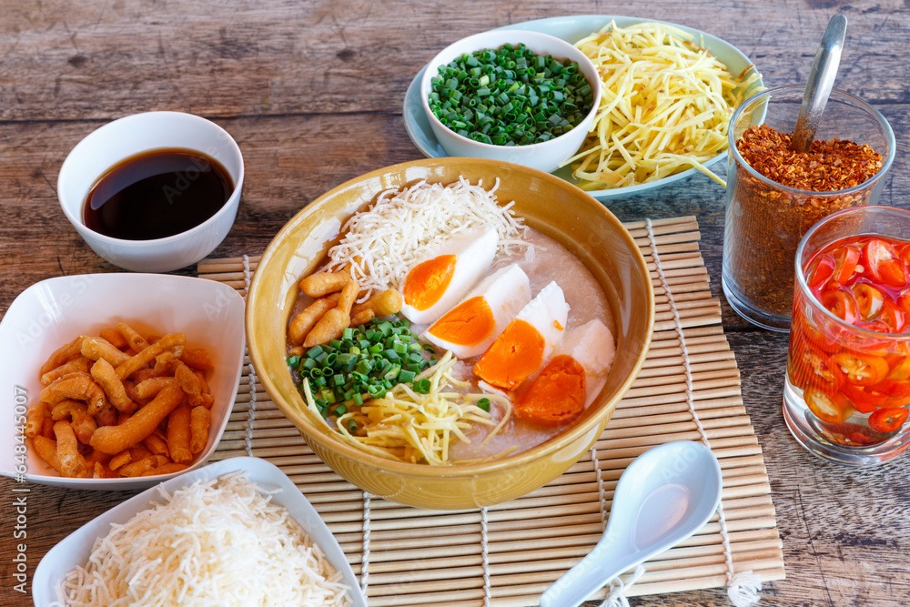 Congee, rice porridge with salted egg, leek, and ginger. Asian healthy ...
