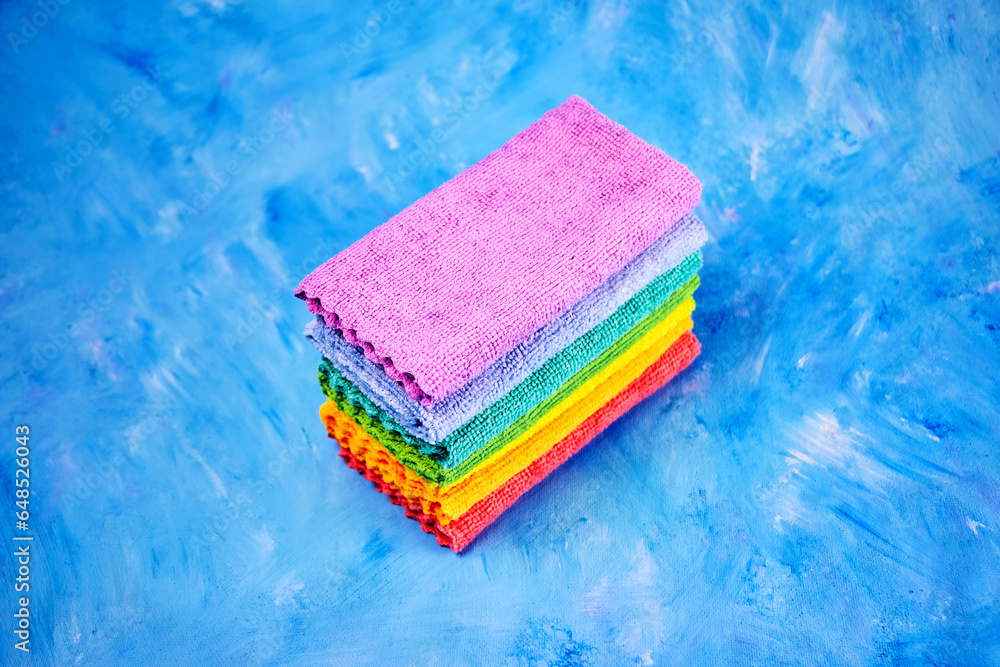 seven rainbow colored cleaning rags lying on top of each other for ...