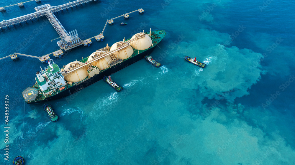 LNG (Liquefied natural gas) tanker anchored in Gas terminal gas tanks ...