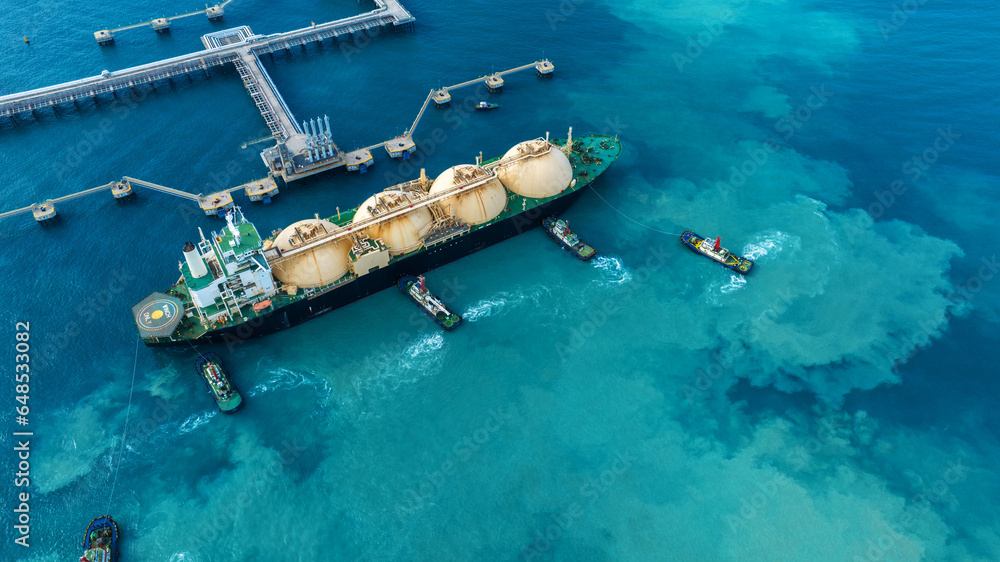 LNG (Liquefied natural gas) tanker anchored in Gas terminal gas tanks ...