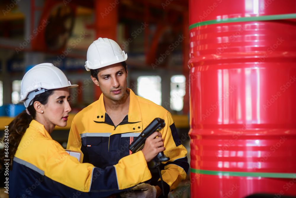 2 Latino male and female auditor wearing safety uniform workwear with ...
