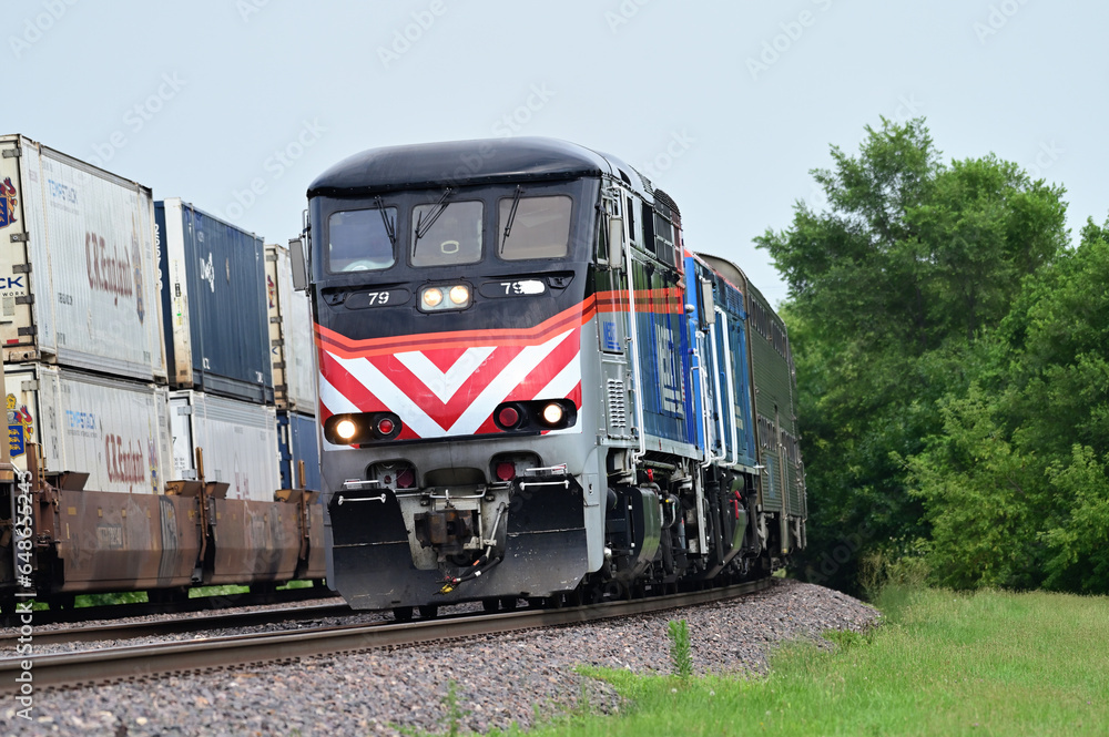 A Union Pacific Railroad intermodal freight train being passed by an ...