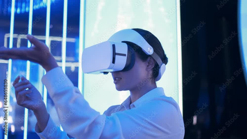Beautiful young female playing game in vr glasses. Happy woman touch ...