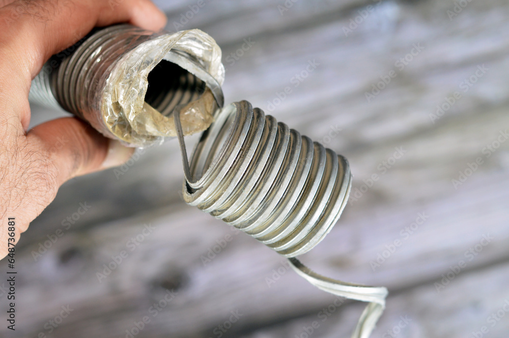 A broken flexible hose from a vacuum cleaner, substandard materials and ...