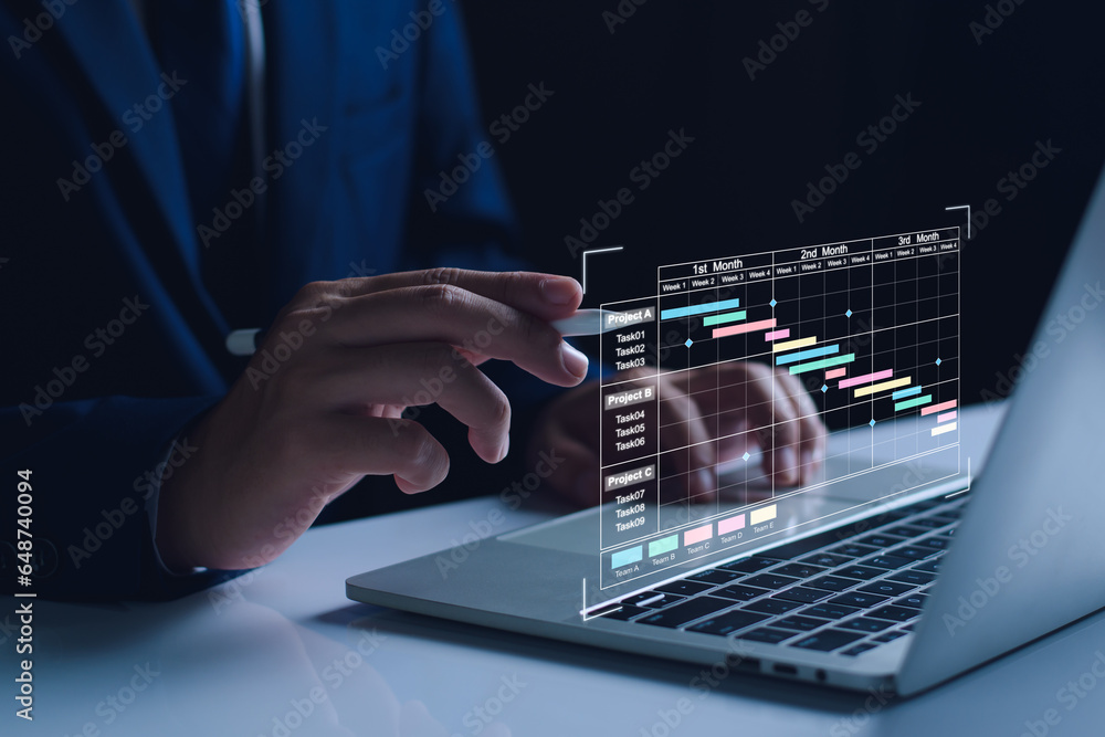 Project manager working on tablet. updating tasks and milestones ...