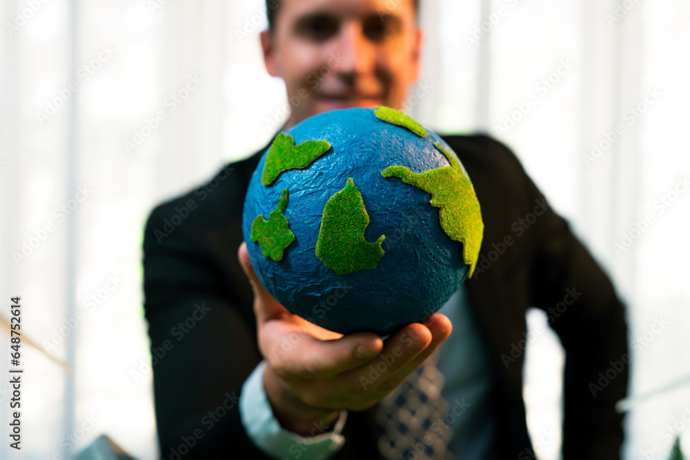 Eco business and save Earth concept shown by businessman or CEO holding ...