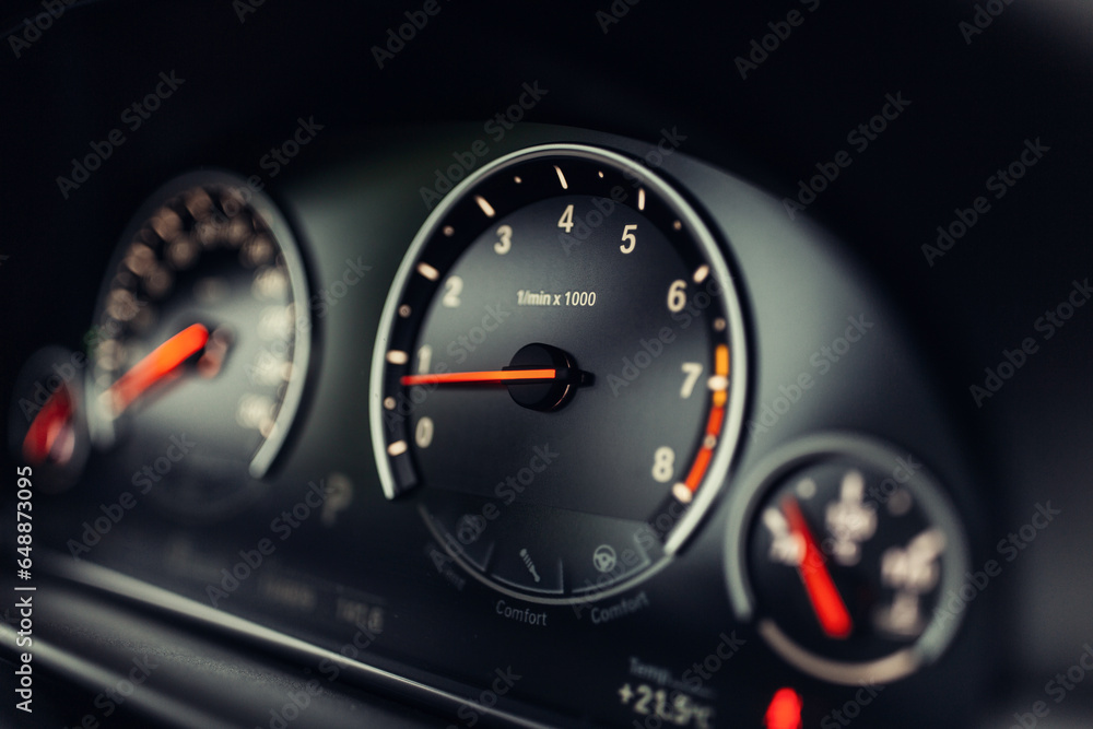 Sports car tachometer and dashboard with backlight. Close-up view of ...