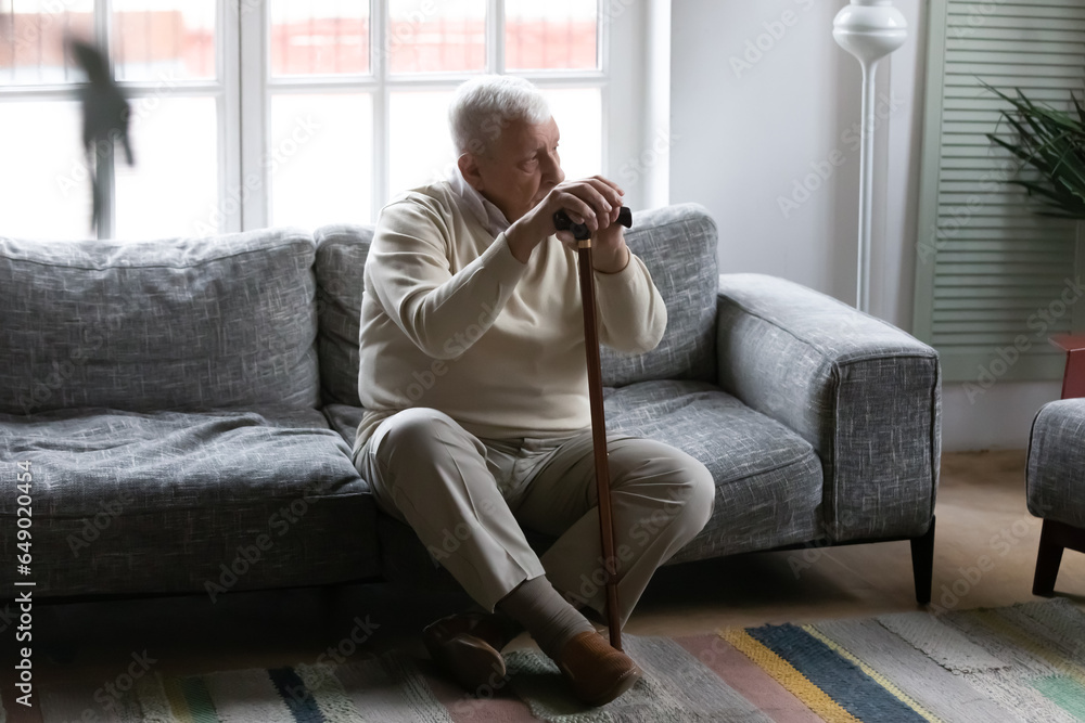 Upset old 80s disabled man sit on couch in retirement house lost in ...