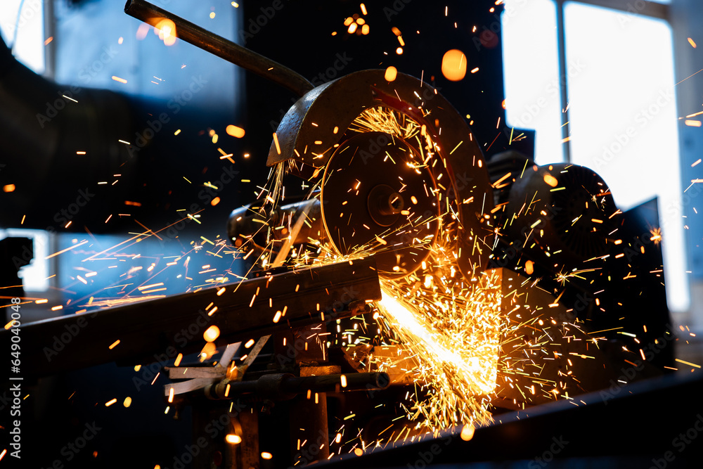 Cutting a metal using cutting machine and the fire sparks splashes ...