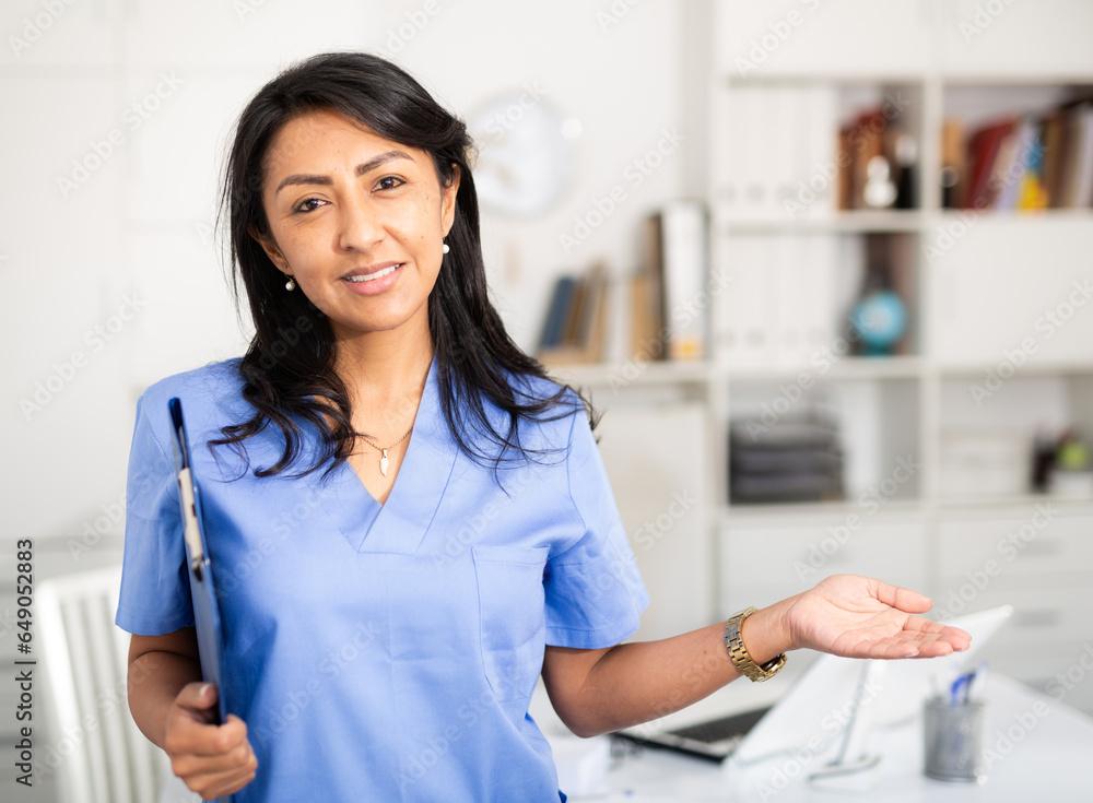 Polite female doctor making welcome gesture, politely inviting patient ...
