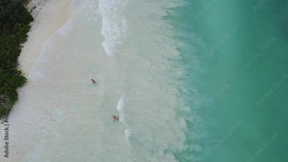 4k aerial footage of a two man swimming in a big ocean waves. Stunning ...