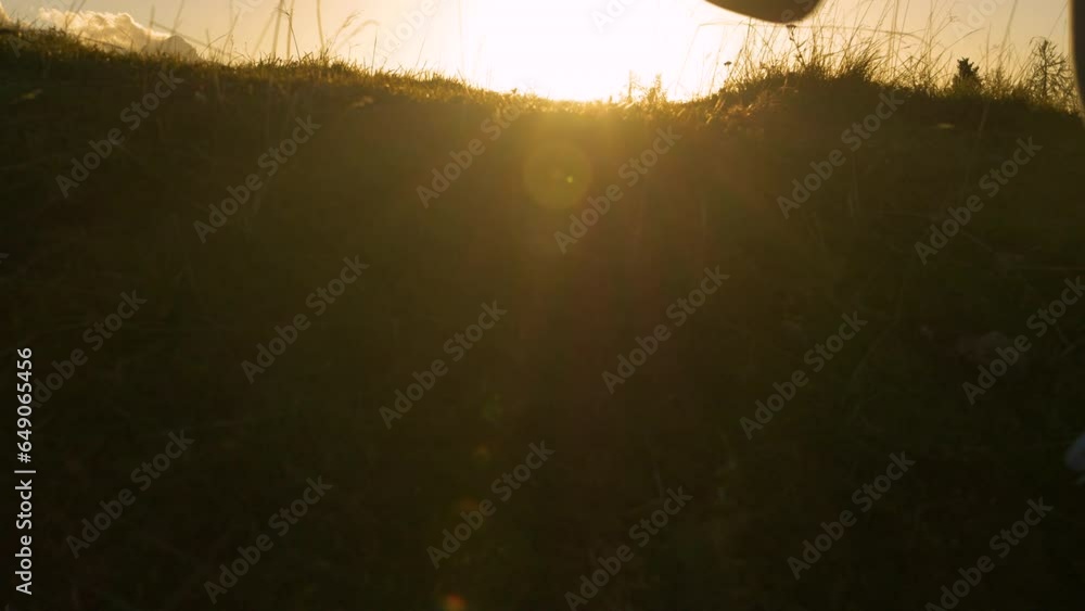 LENS FLARE: Lady reaches top of a scenic hill after running and jumps ...