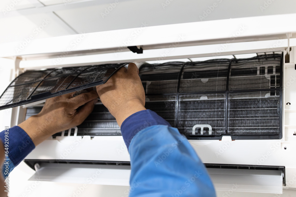 Technician putting on air filter after cleaning or replacing the new ...