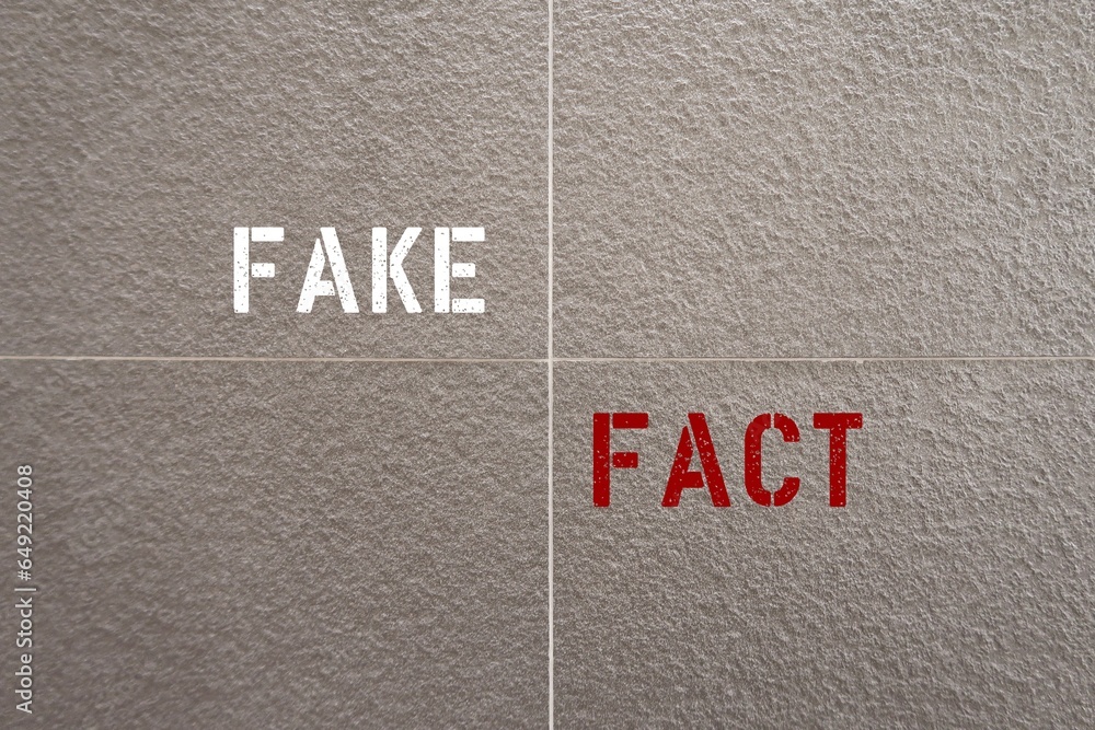 Wall with text FAKE and FACT,concept of awareness before spreading made ...